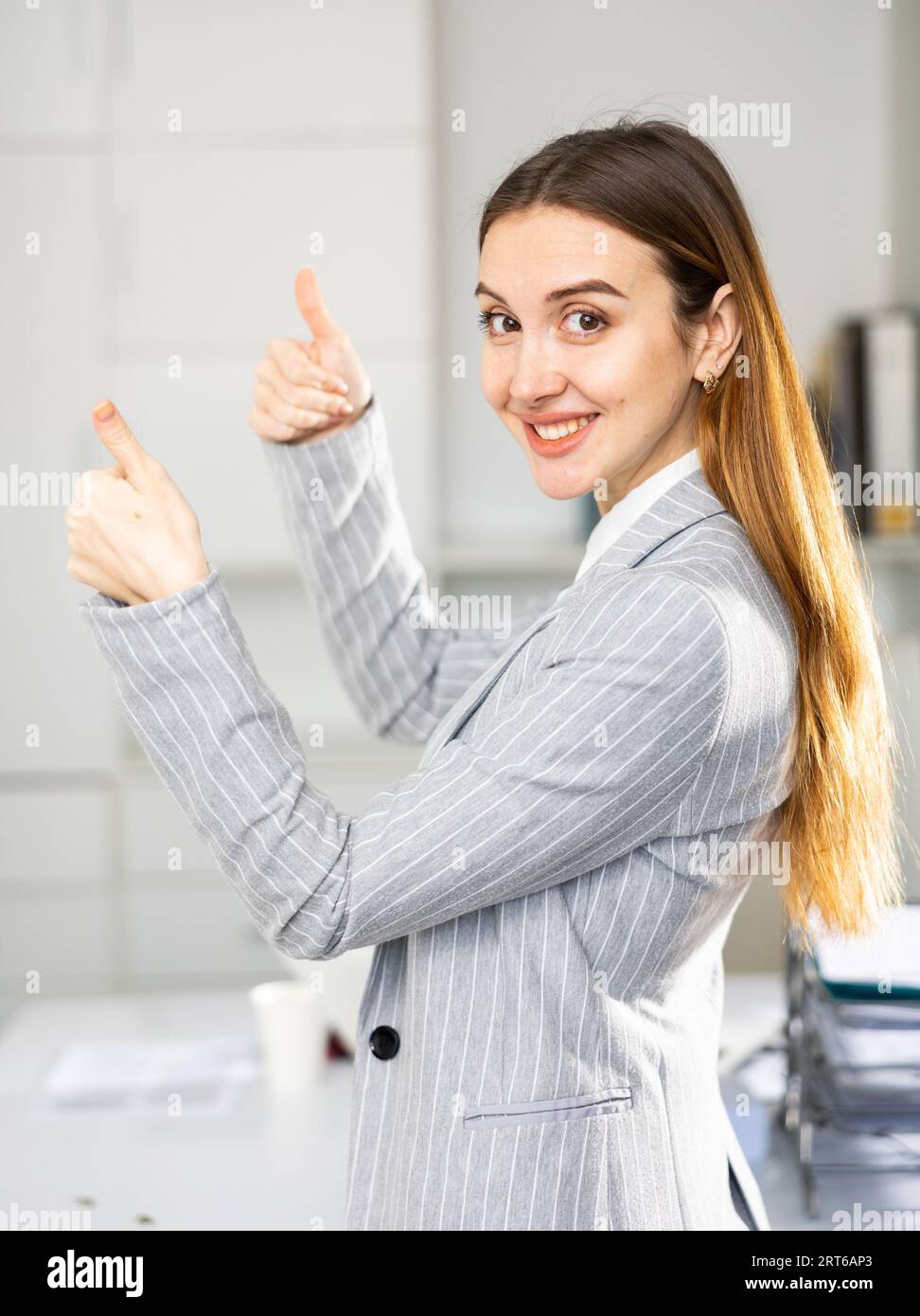 Business woman standing in office and pointing Stock Photo - Alamy