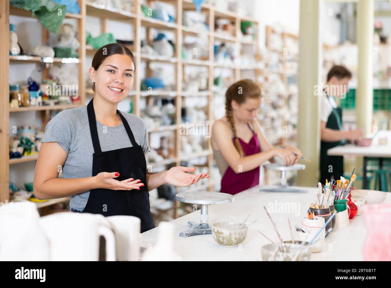 Female master potter invites you to pottery lessons Stock Photo - Alamy