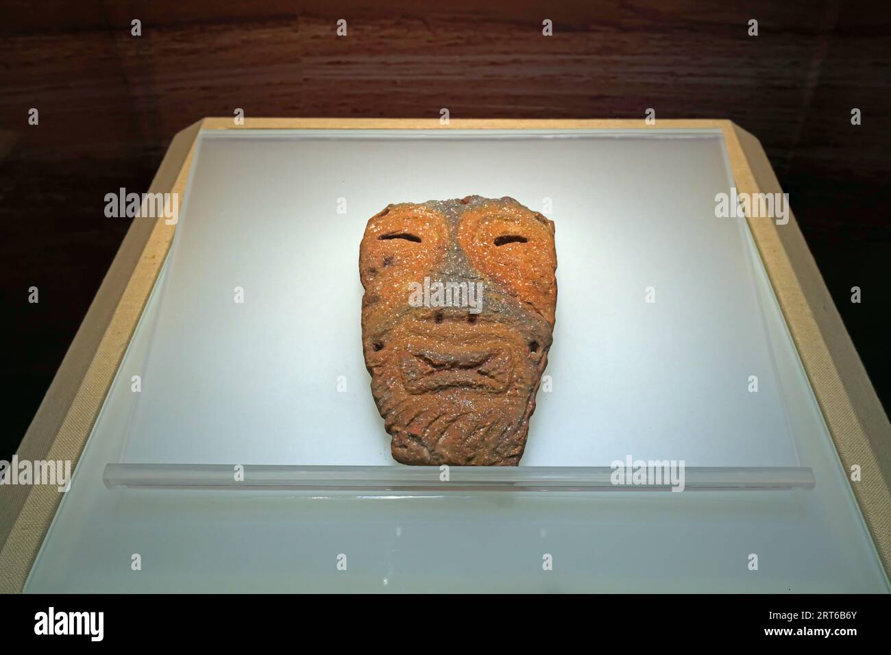 Ancient Chinese pottery masks in the exhibition hall Stock Photo - Alamy