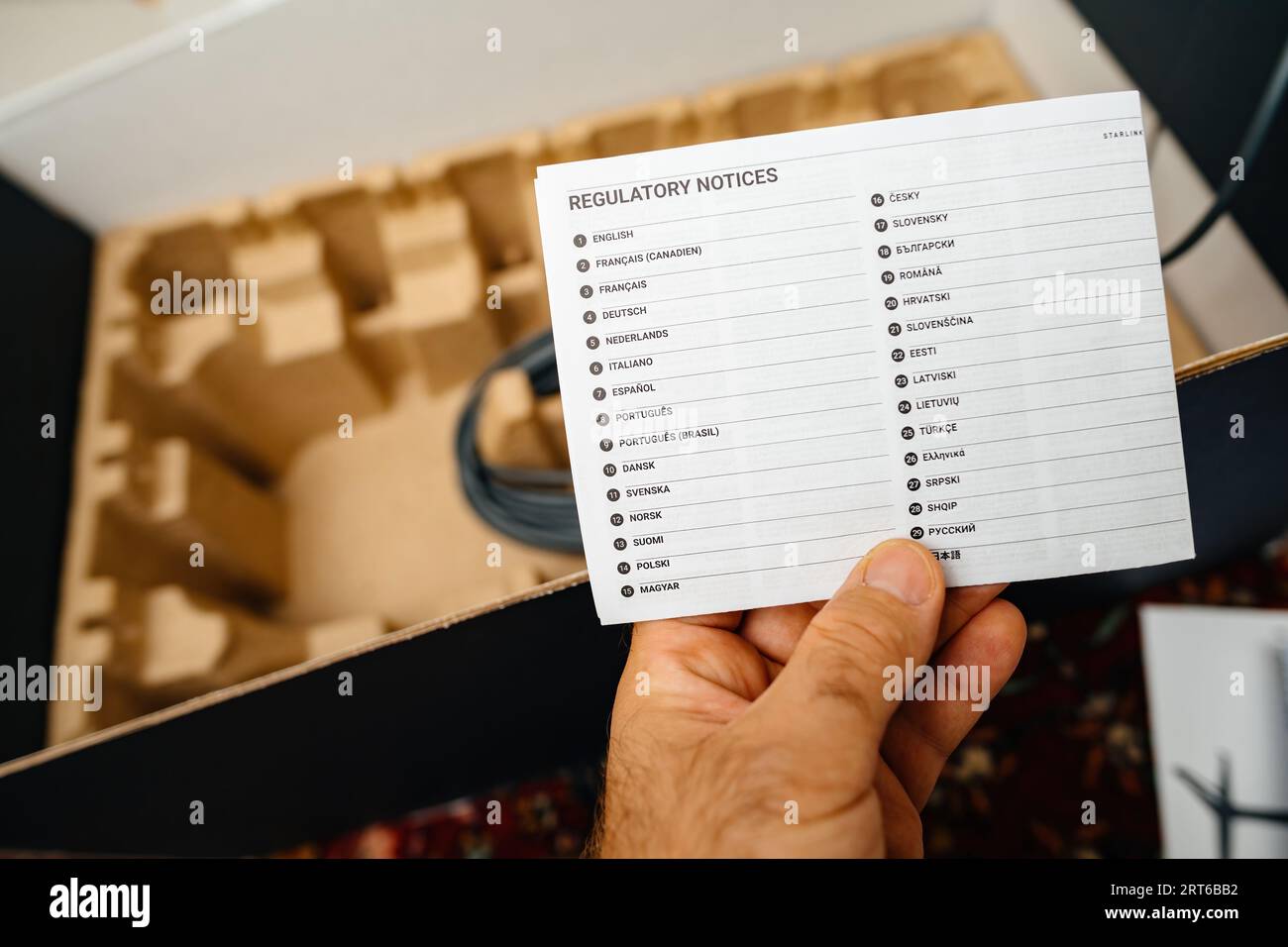 Bremen, Germany - Aug 14, 2023: reading the regulatory notices booklet ...