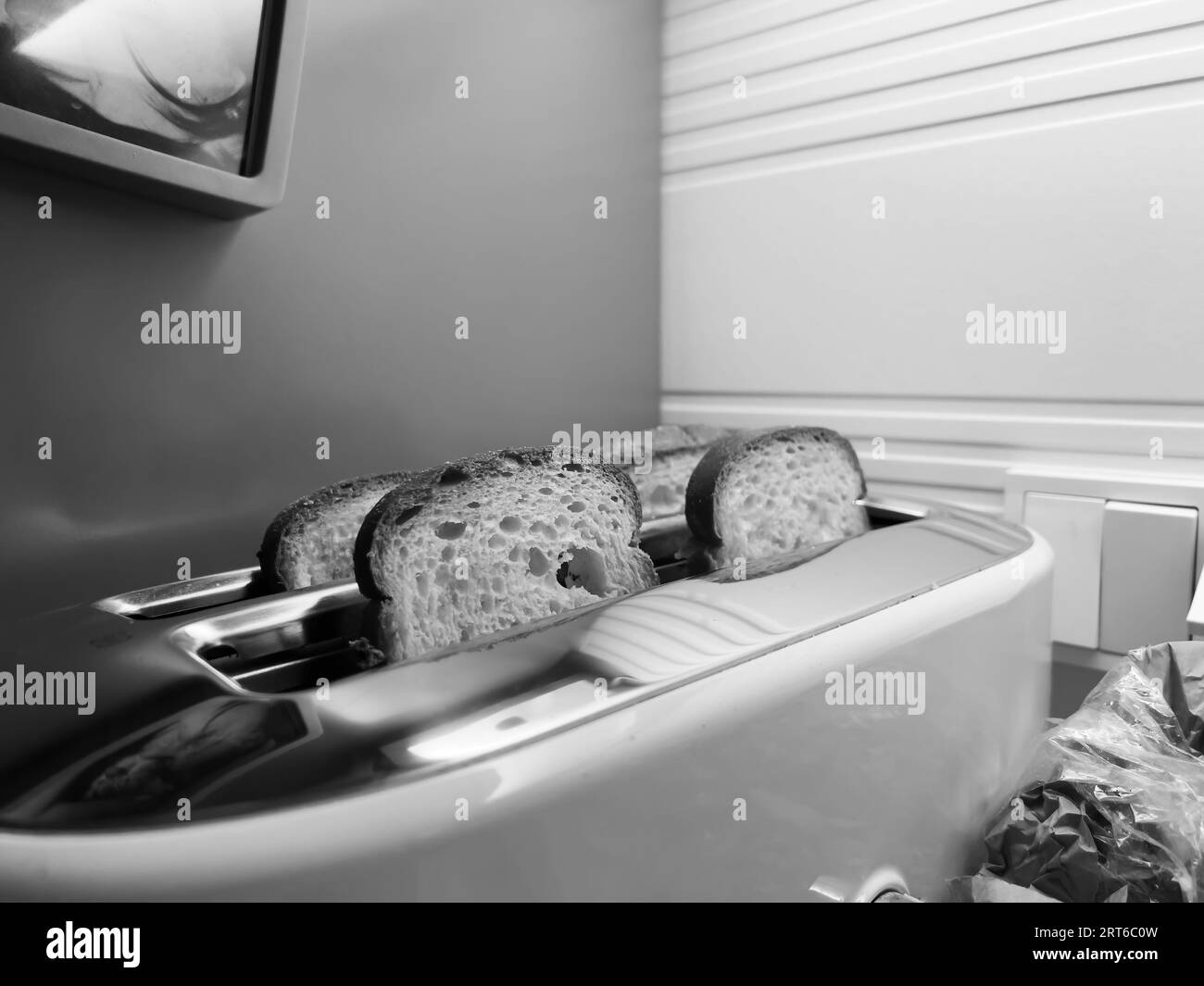 A classic black and white photograph of four slices of bread snugly ...