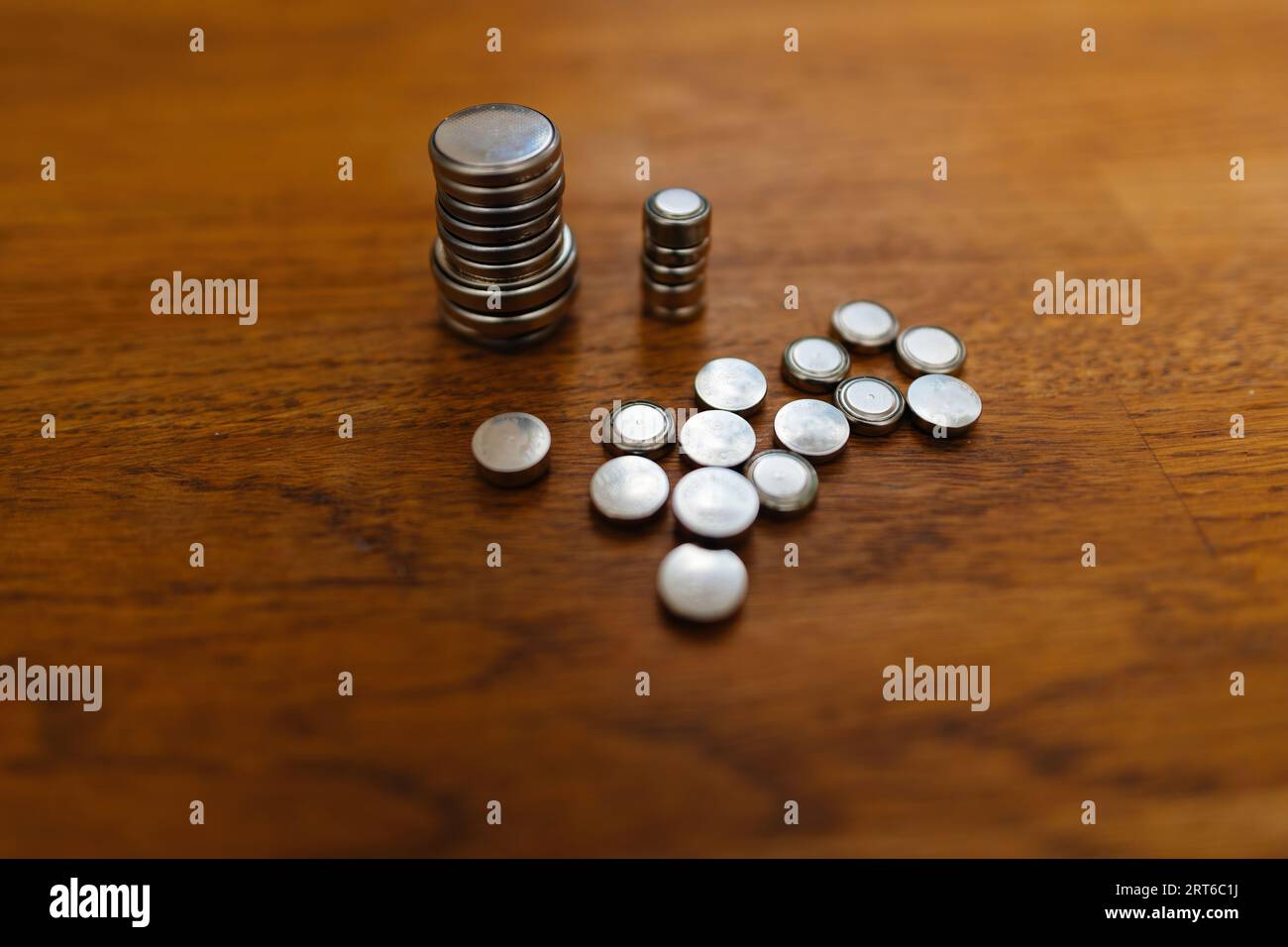 A macro capture reveals button cells meticulously arranged in varied ...