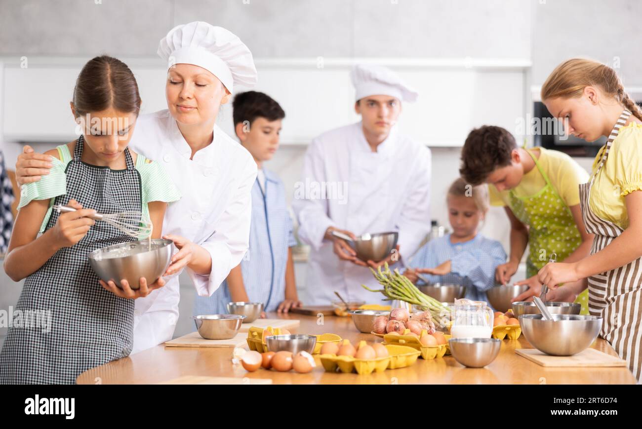 Woman calms down sad girl who cant beat raw eggs properly in cooking ...