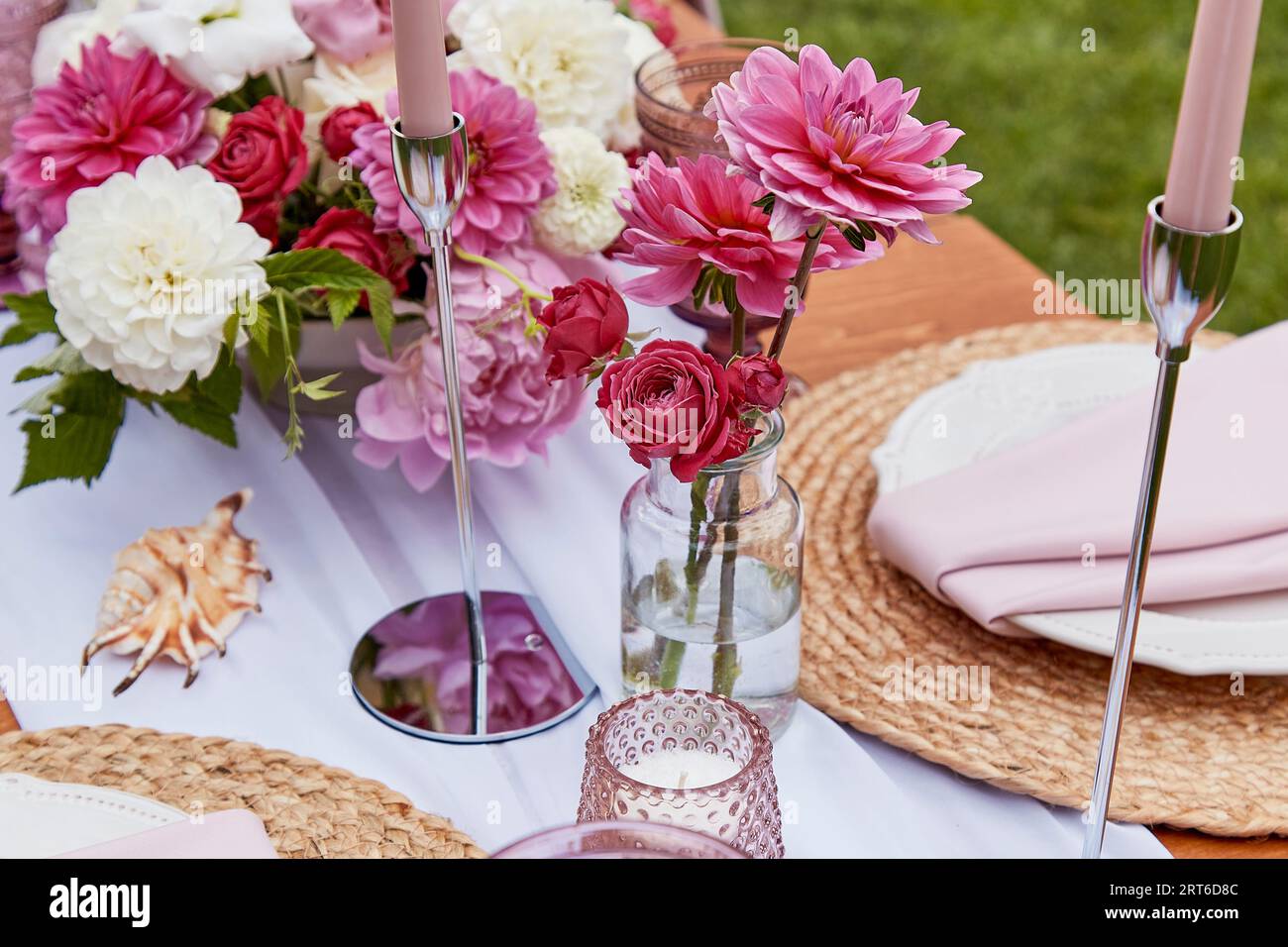 Picnic aesthetics table setting, flowers arrangement, shells. Cozy setup with flowers and ...