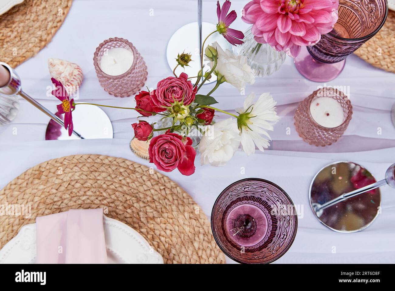 Table setting graced by candles and flowers arrangement. The wedding ...