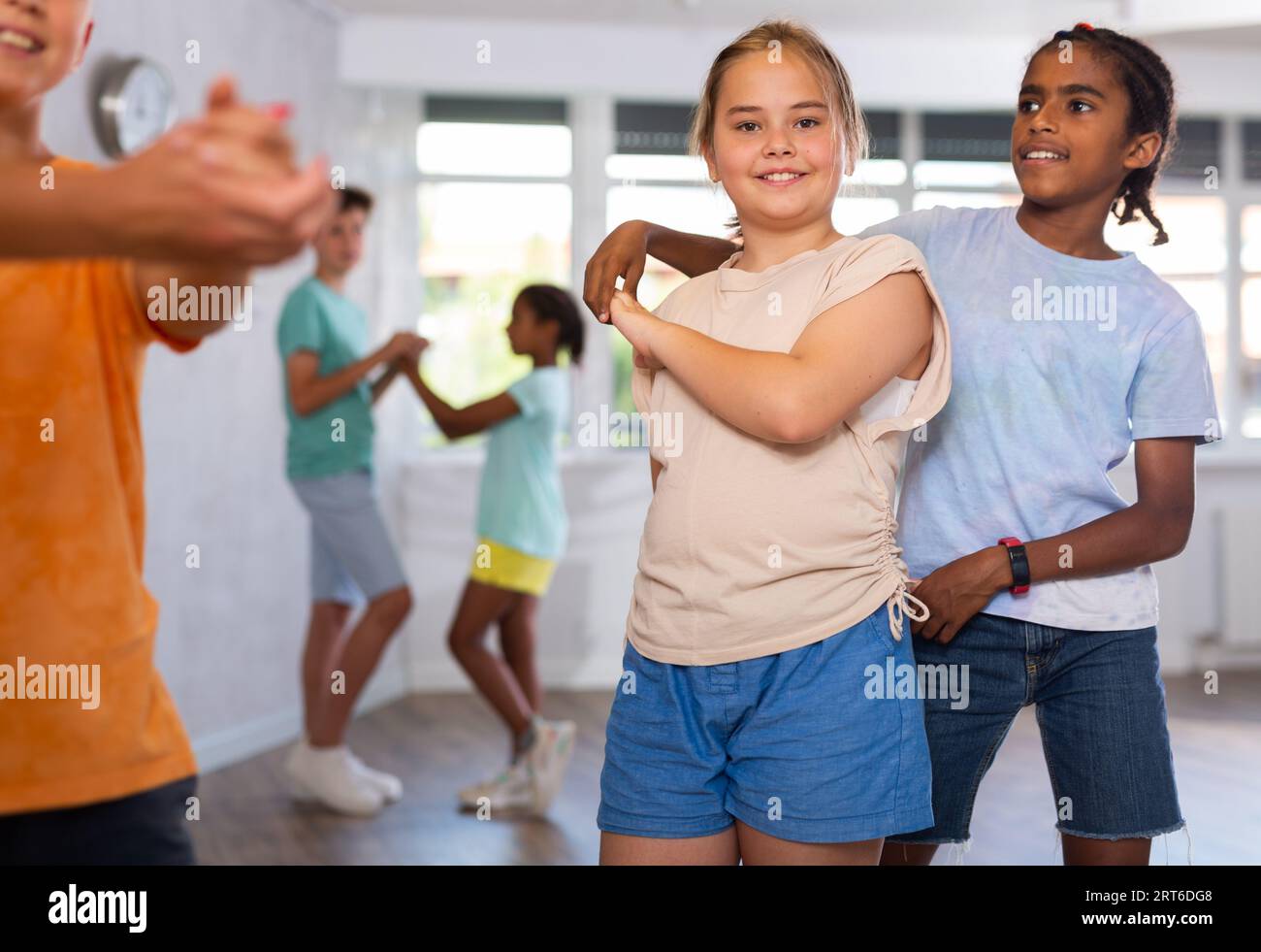 African boy and European girlie learn figures of pair jive dance and ...