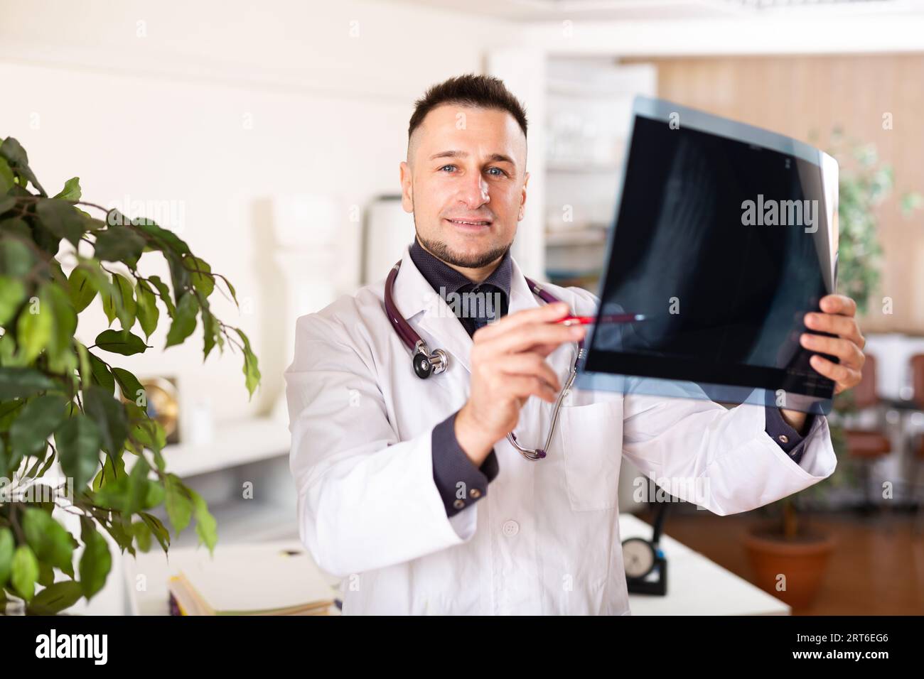 Male doctor examining x-ray at clinic Stock Photo - Alamy
