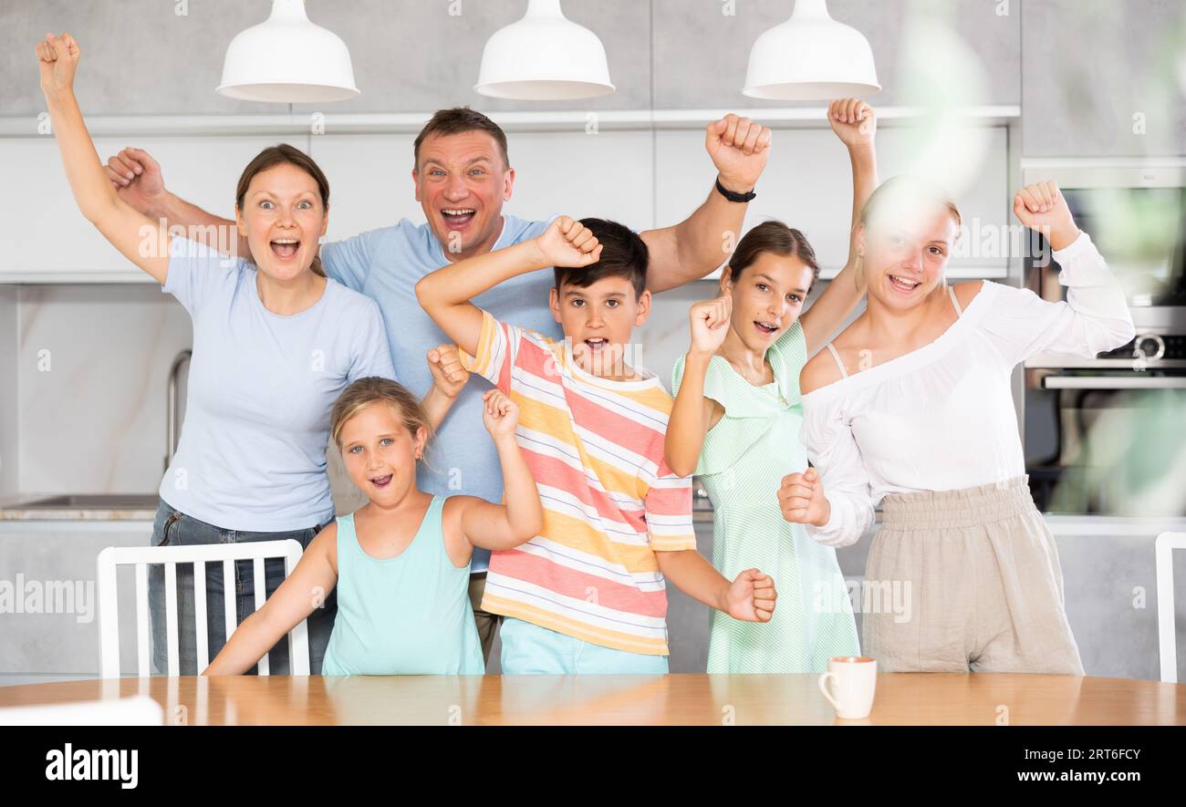 Portrait of happy family, children and parents scream with joy and hold ...