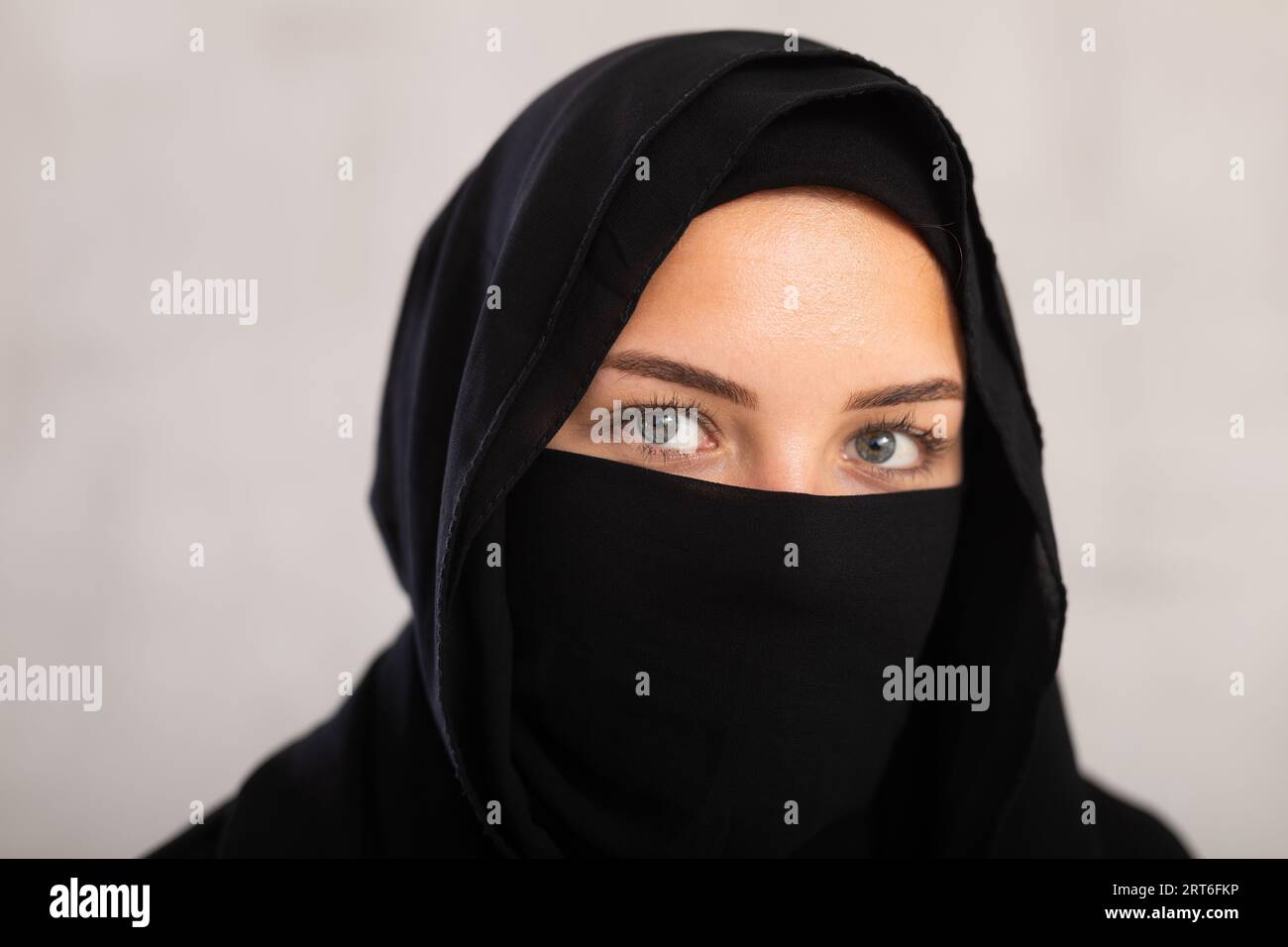 Young woman dressed in traditional islamic clothes with her face ...
