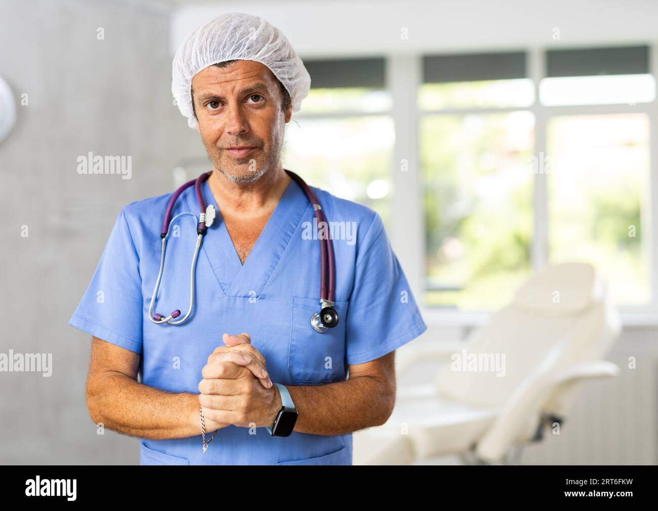 Portrait of male doctor cosmetologist wearing white overall showing ...