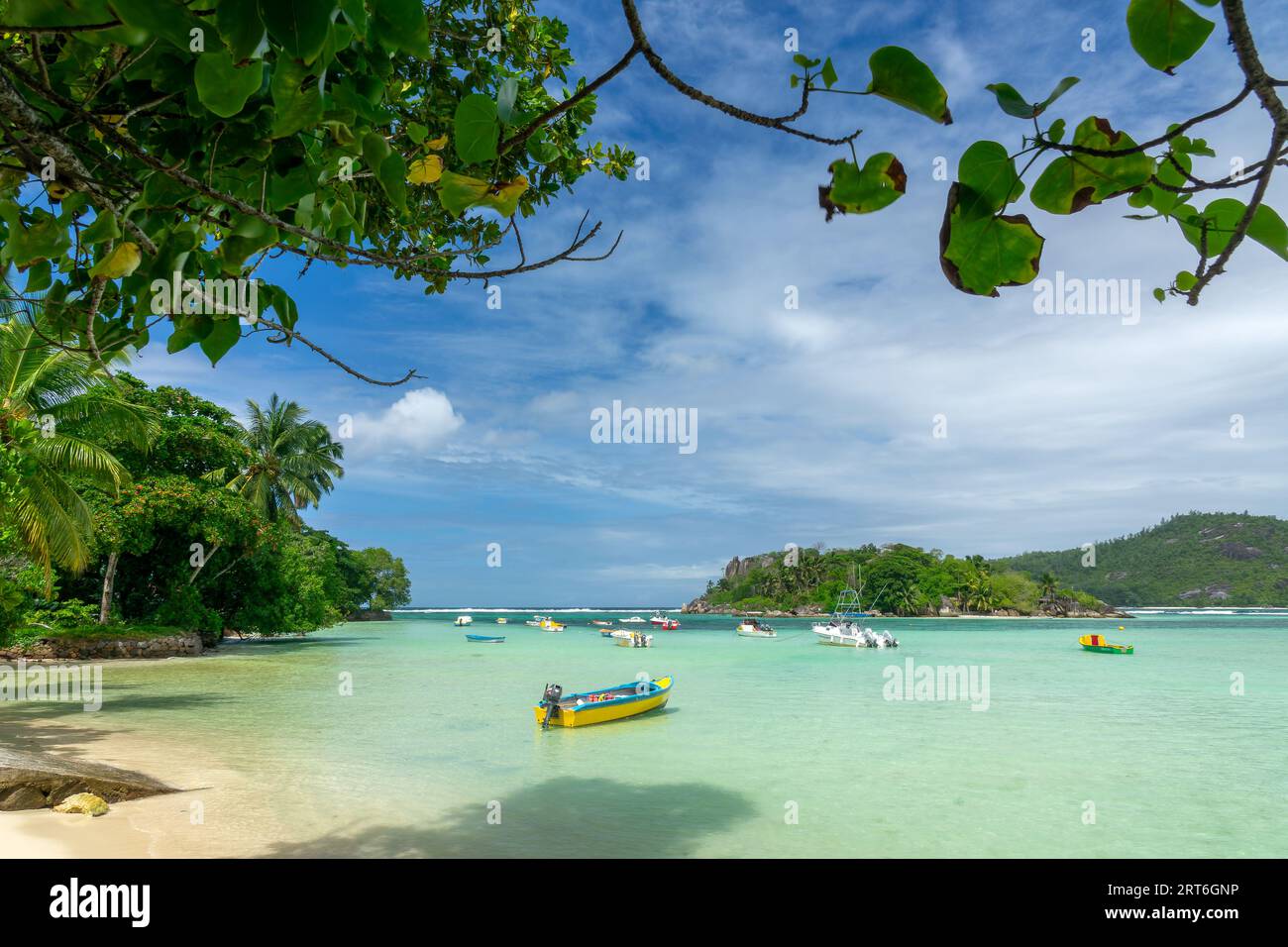 Colorful boats and transparent water in the lagoon of Anse l'Islette ...