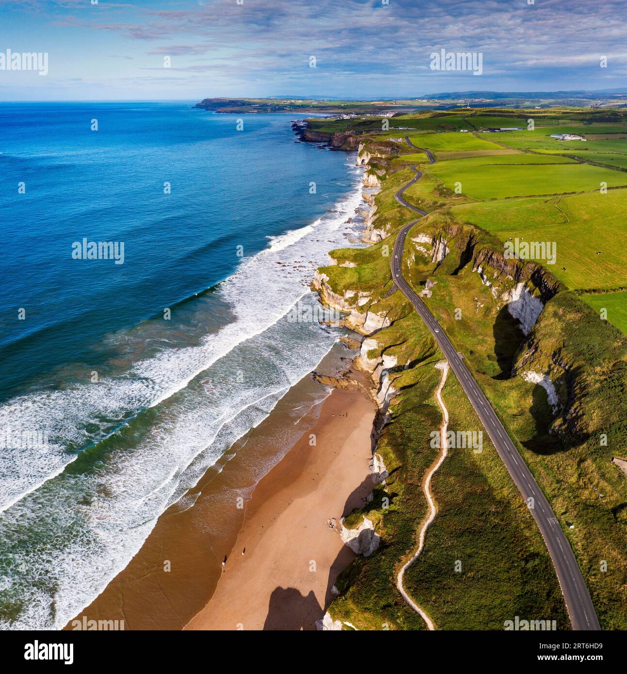 Aerial of the Causeway Coastal Road at White Rocks, Dunluce Castle ...