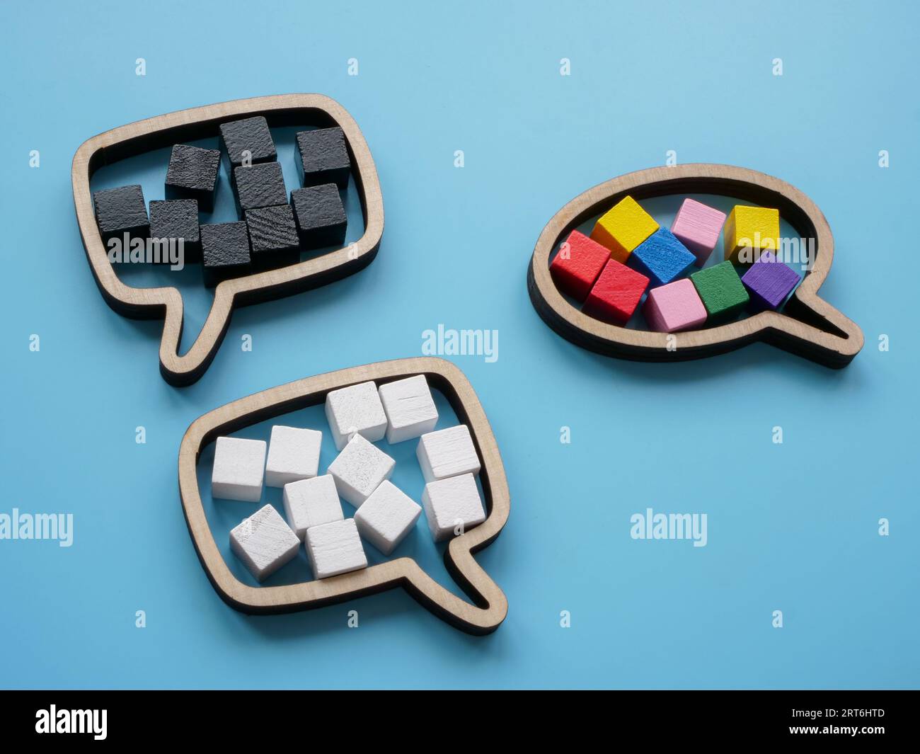 Wooden speech bubbles and cubes as a symbol of different approaches and ...