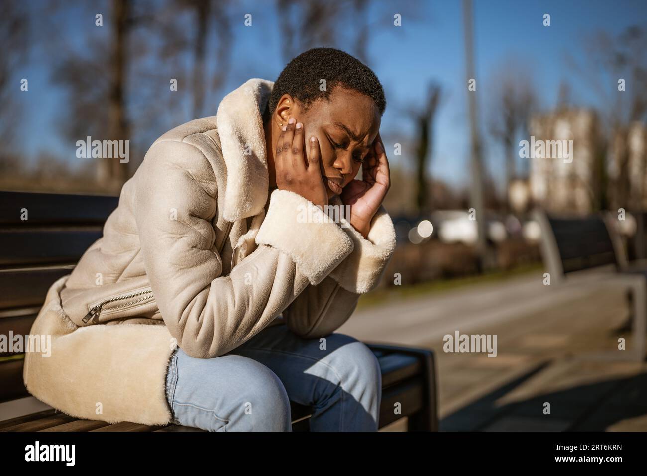 Outdoor portrait of depressed african-american woman on sunny day. She ...