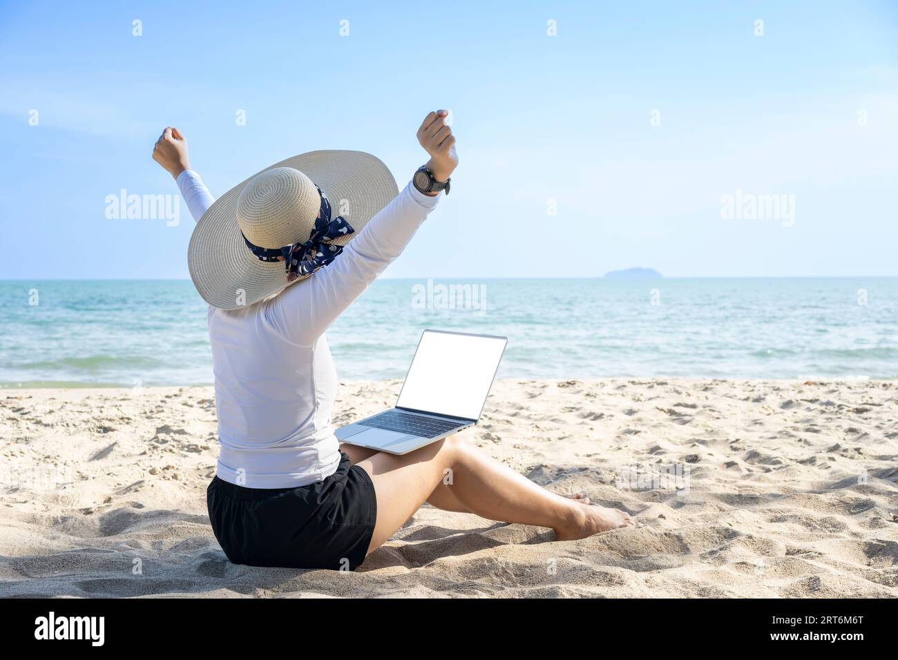 Work from anywhere concept. Rear view of young woman working on ...