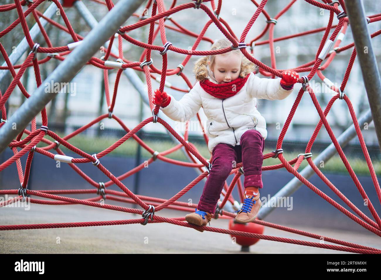Adorable preschooler girl having fun in adventure park. Child on tree ...