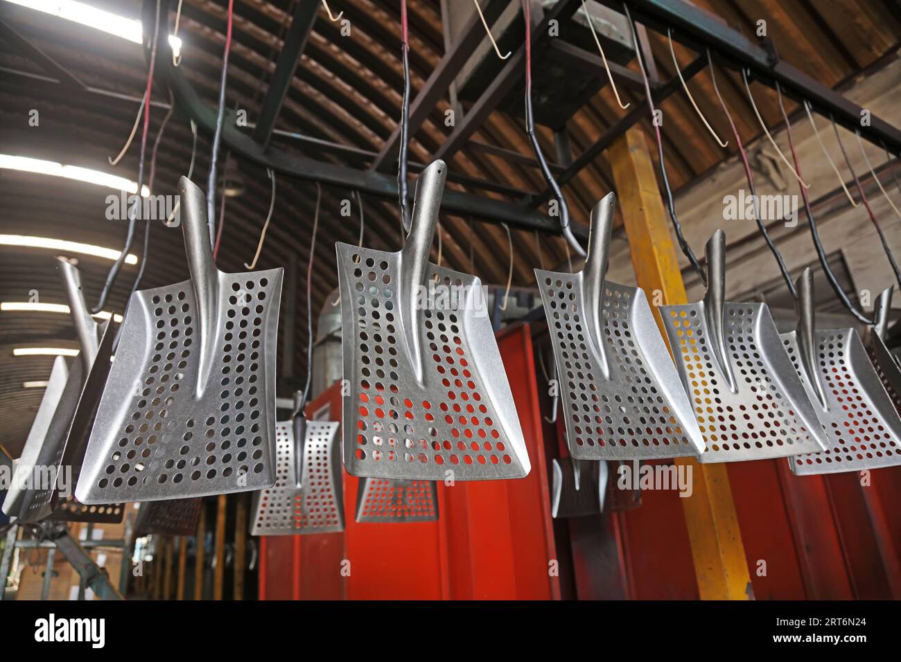 Steel spade with holes in production line Stock Photo - Alamy