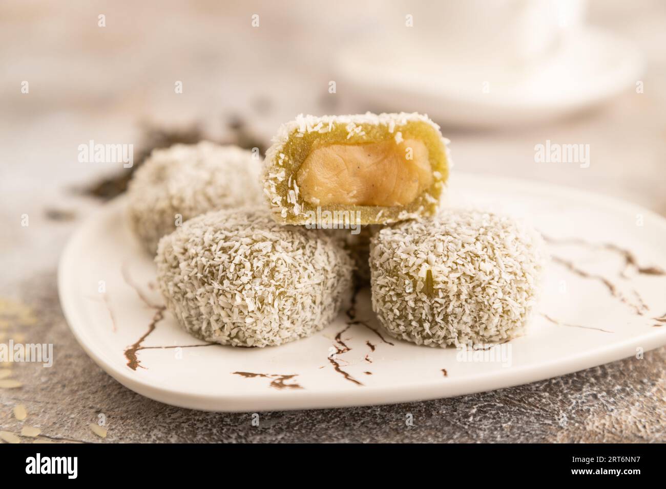 Japanese rice sweet buns mochi filled with pandan jam and cup of green ...