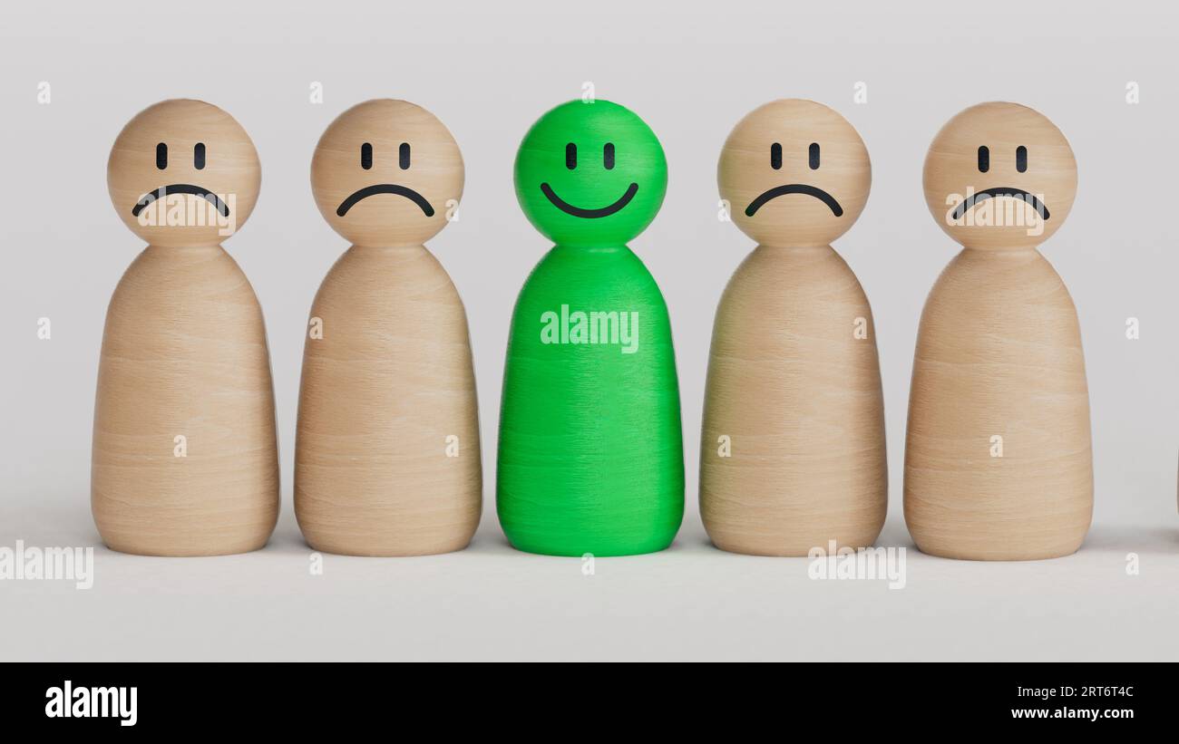 Smiley face on wooden mixture figure separate from sadness face on ...