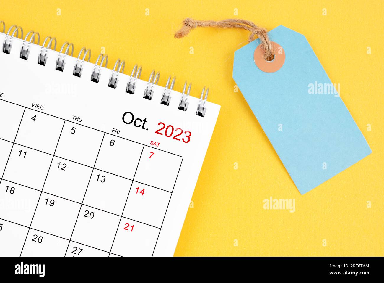 October 2023 desk calendar with blank price tag on yellow background ...