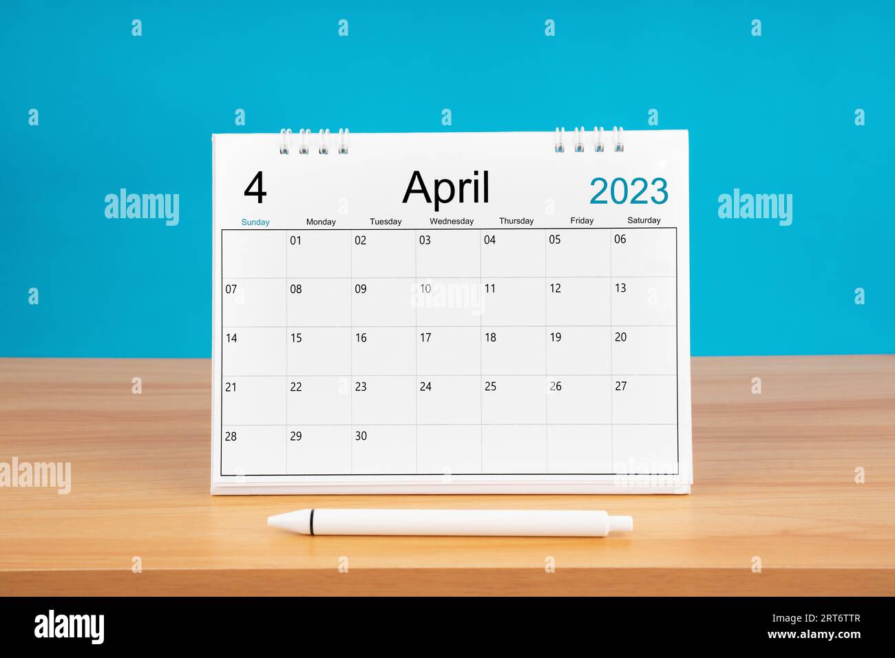 April monthly desk calendar for 2024 year and pen on wooden table with ...