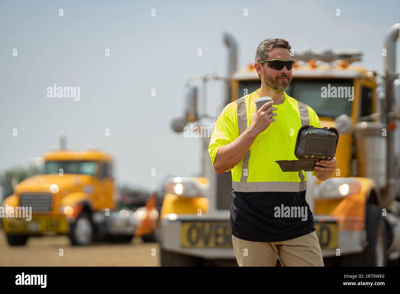 Men driver near lorry trucks. Man owner truck driver in safety vest ...