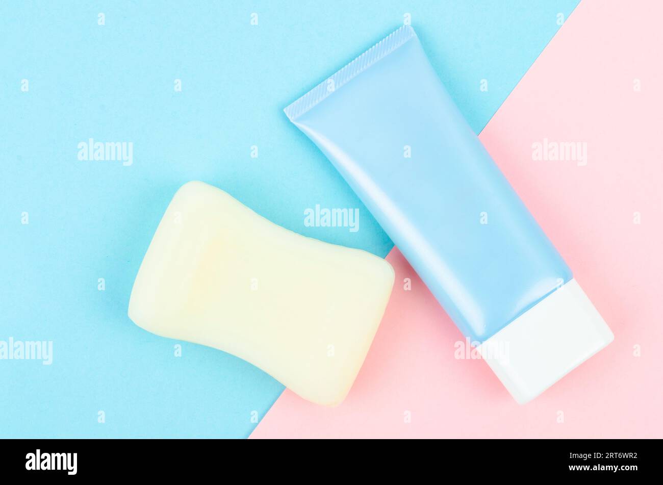 Top view blue squeeze bottle plastic tube and herb soap bar on ...