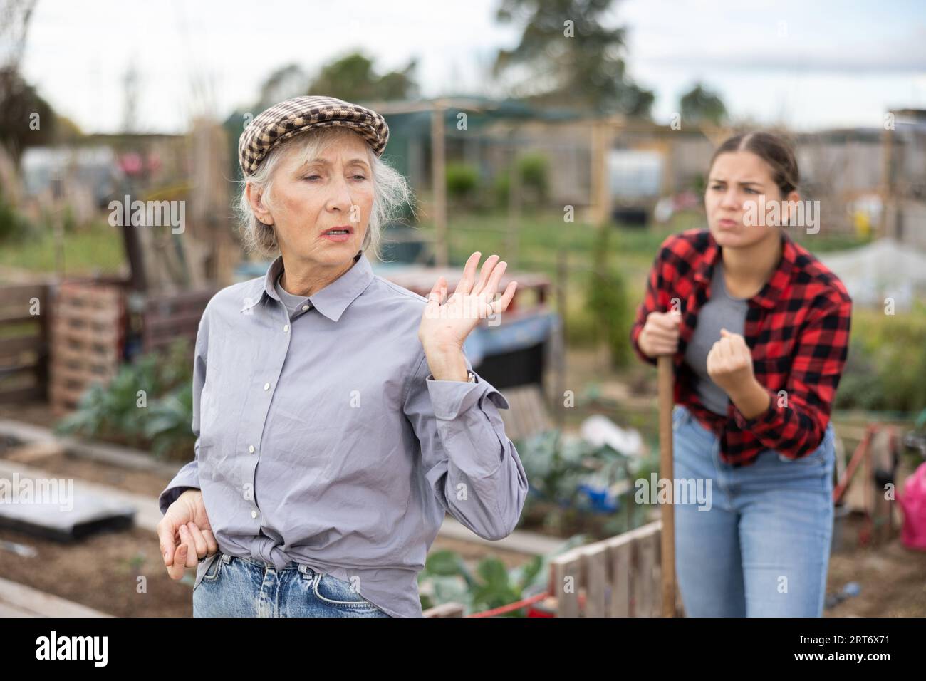 Two angry casual women neighbors of different ages arguing during the ...