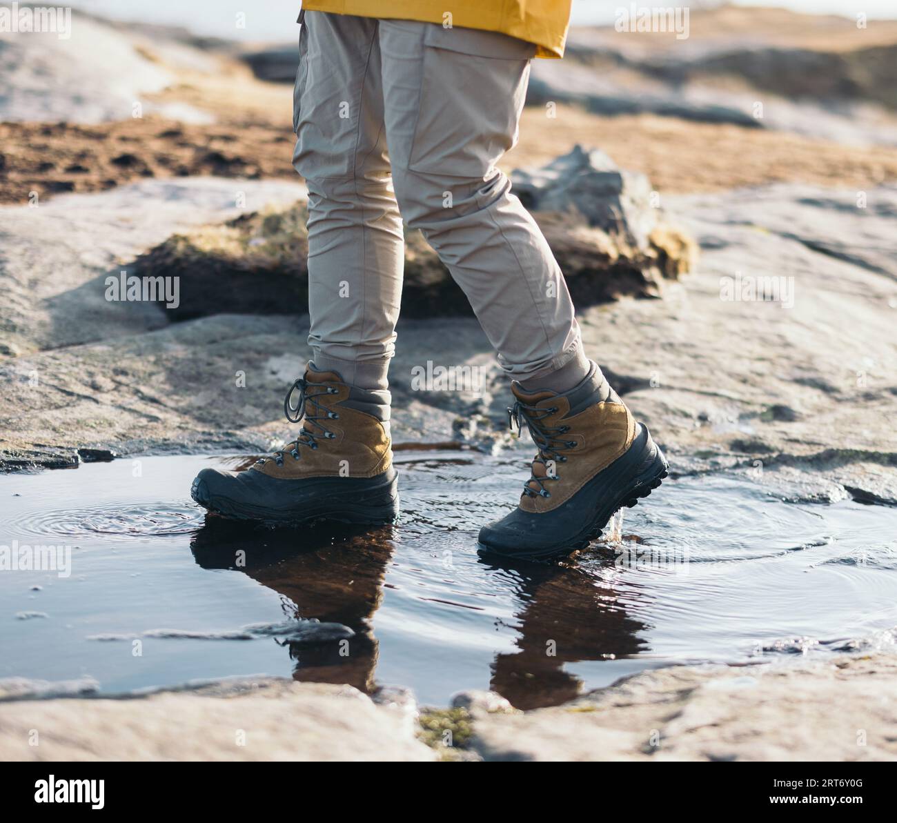 Side view of unrecognizable person wearing boots and white trousers ...