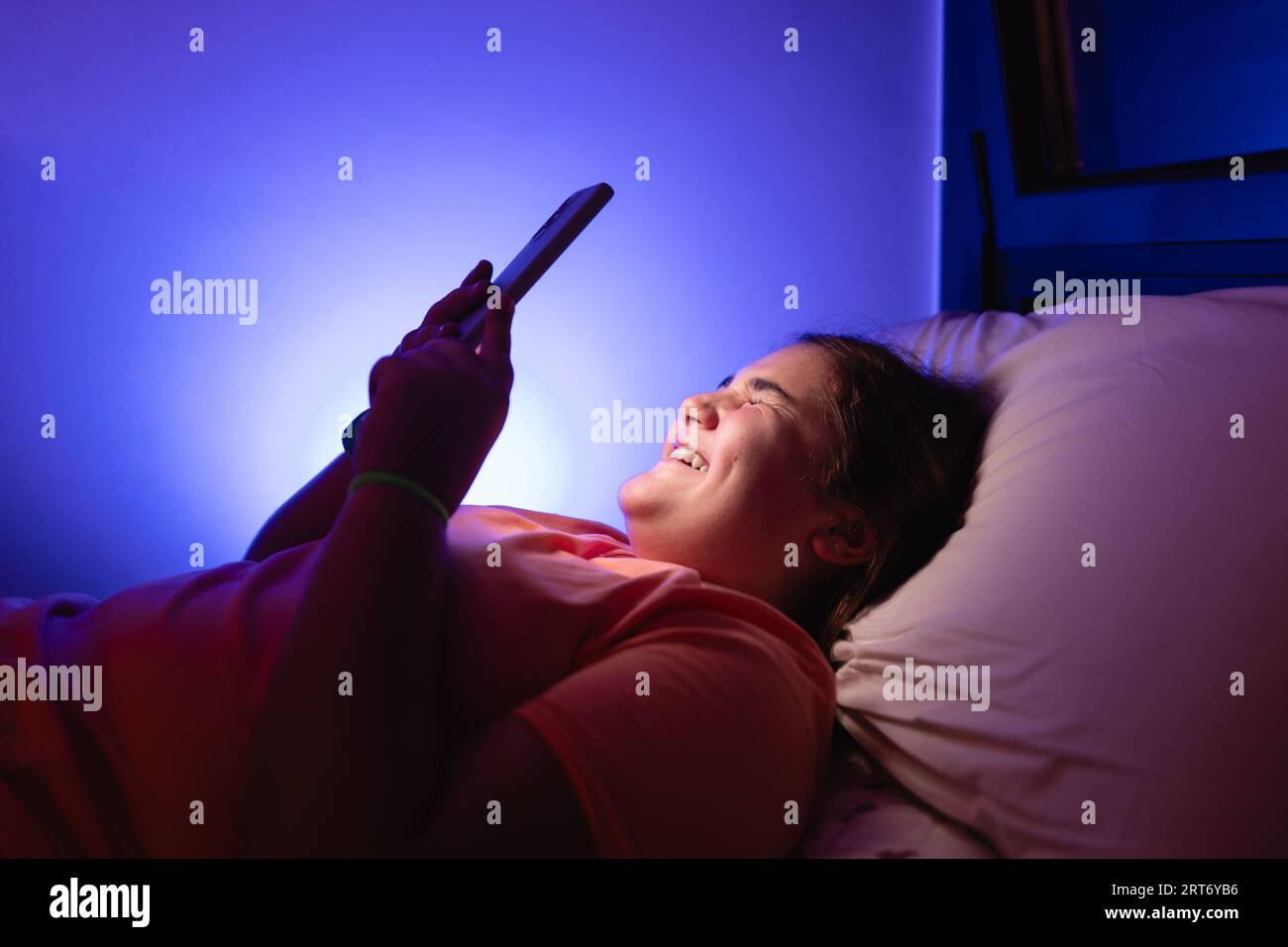 Side view of frightened teenage girl with eyes closed while lying on ...