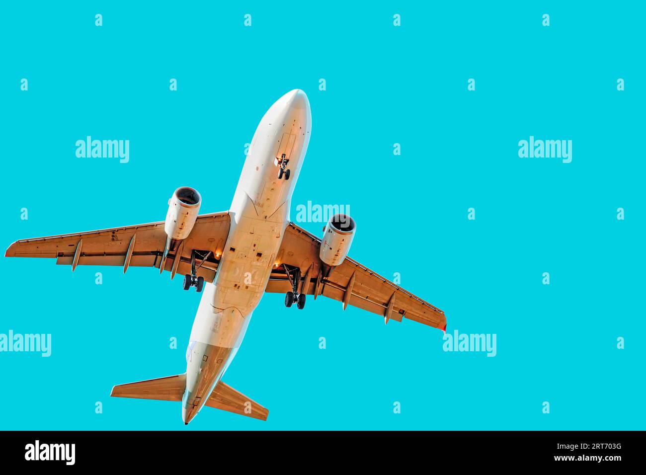 A commercial aircraft is pictured mid-flight in a clear blue sky ...
