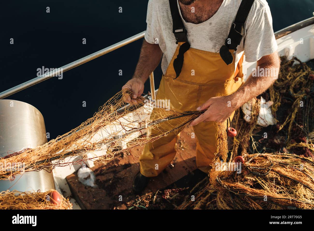 From above cropped unrecognizable male fisher in uniform seiner hunting ...