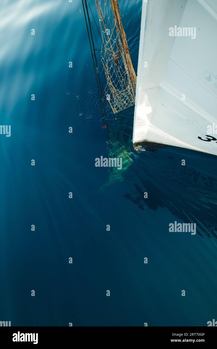 Top view of sailing boat floating with fishing tackle in open sea in ...