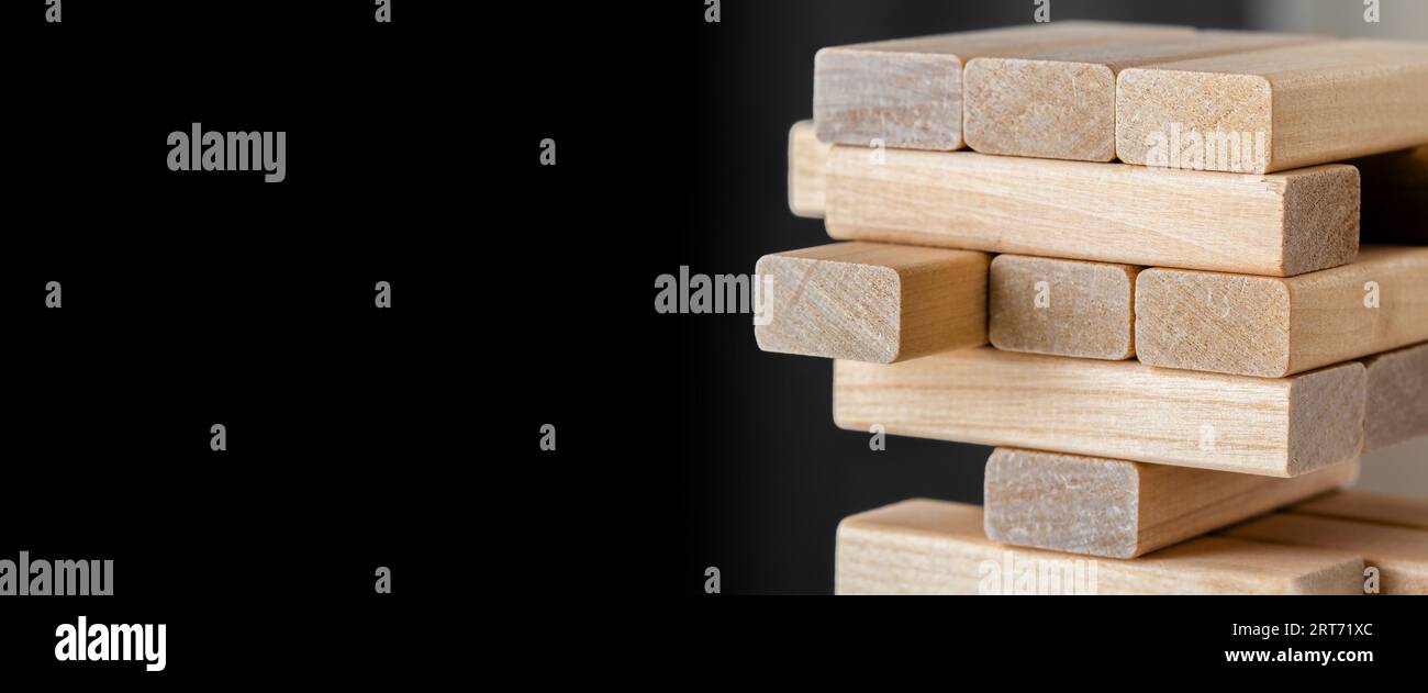 Wooden blocks tower with copy space on black background Stock Photo - Alamy