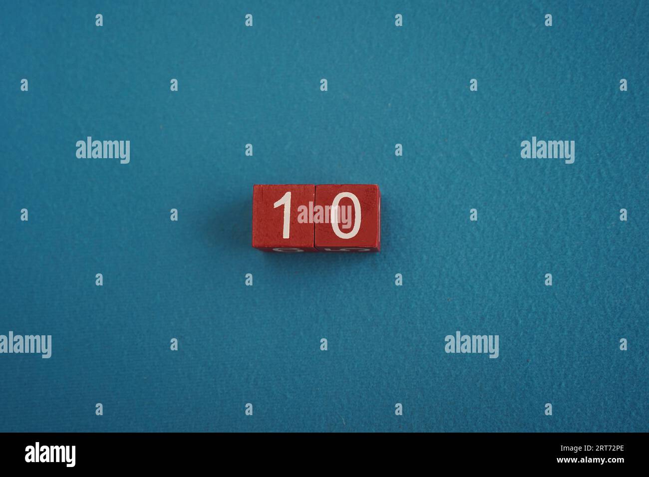 Wooden Viva Magenta cubes with number 10 on blue background close-up ...