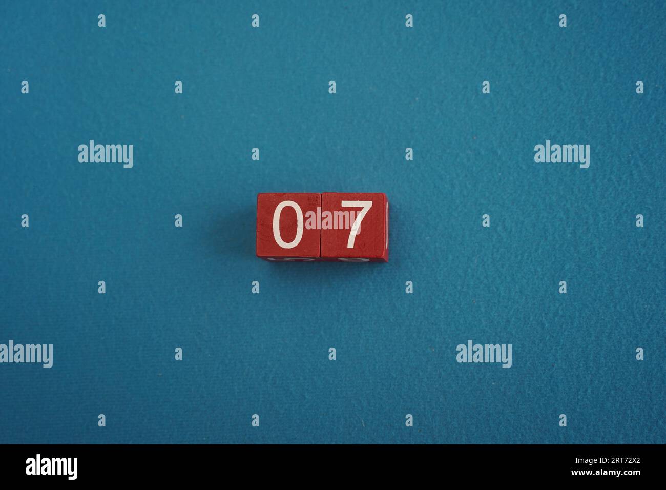 Wooden Viva Magenta cubes with number 7 on blue background close-up top ...