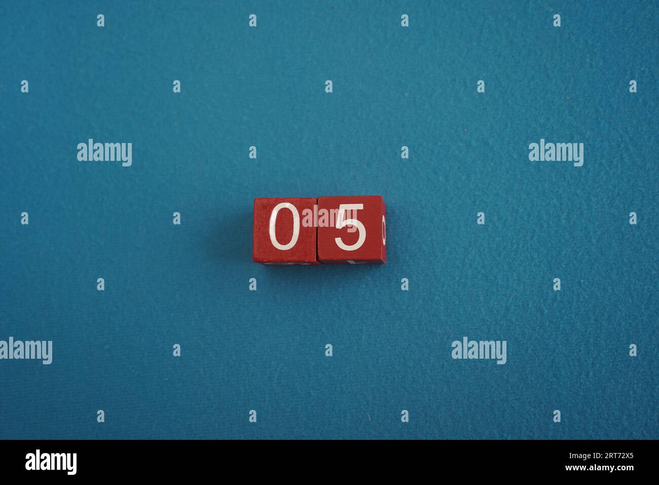 Wooden Viva Magenta cubes with number 5 on blue background close-up top ...