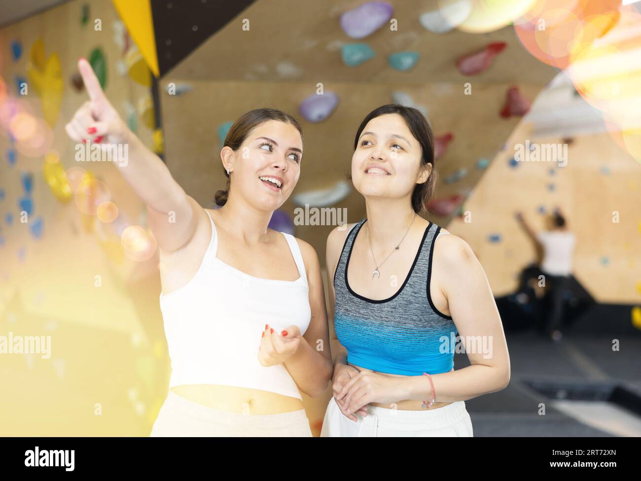 Two women discuss options for overcoming obstacles on an artificial ...