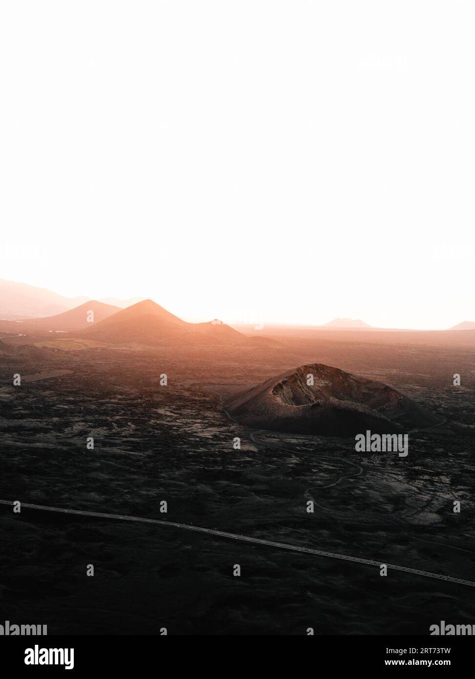Landscape vertical image - Volcanoes in Lanzarote on sunset. Moody and ...