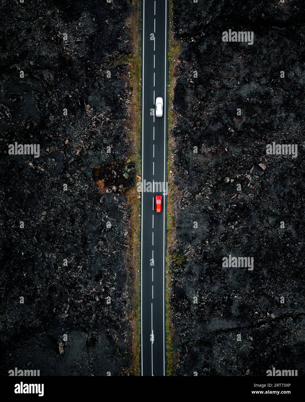 Vertical photo of the road with two cars with motion blur from above by ...