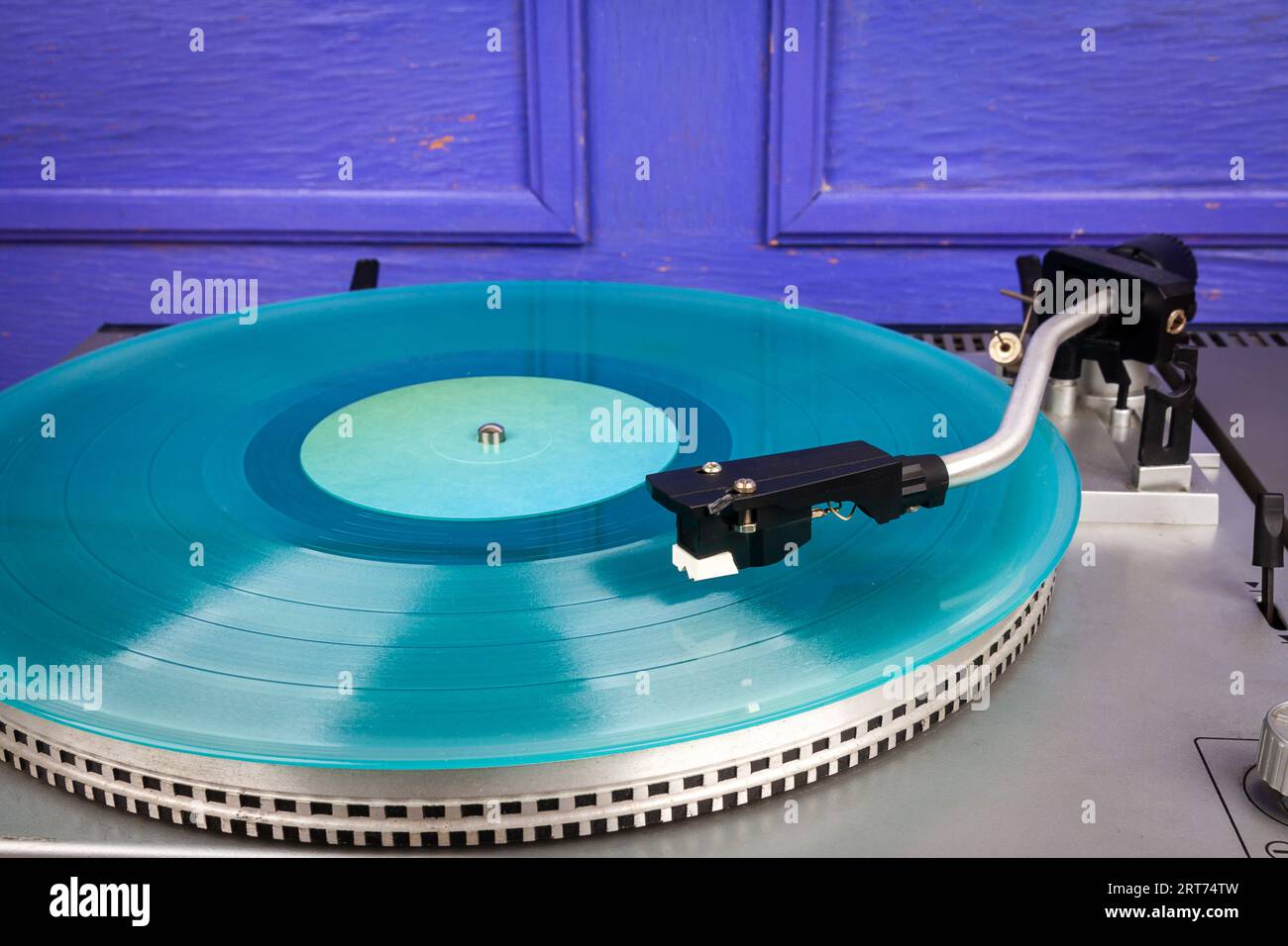 Close up of vintage turntable vinyl record player with turquoise vinyl on a table Stock Photo ...