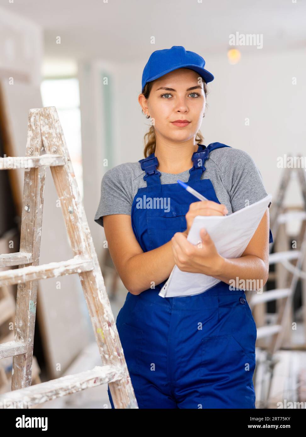 Woman construction worker with project documentation Stock Photo - Alamy