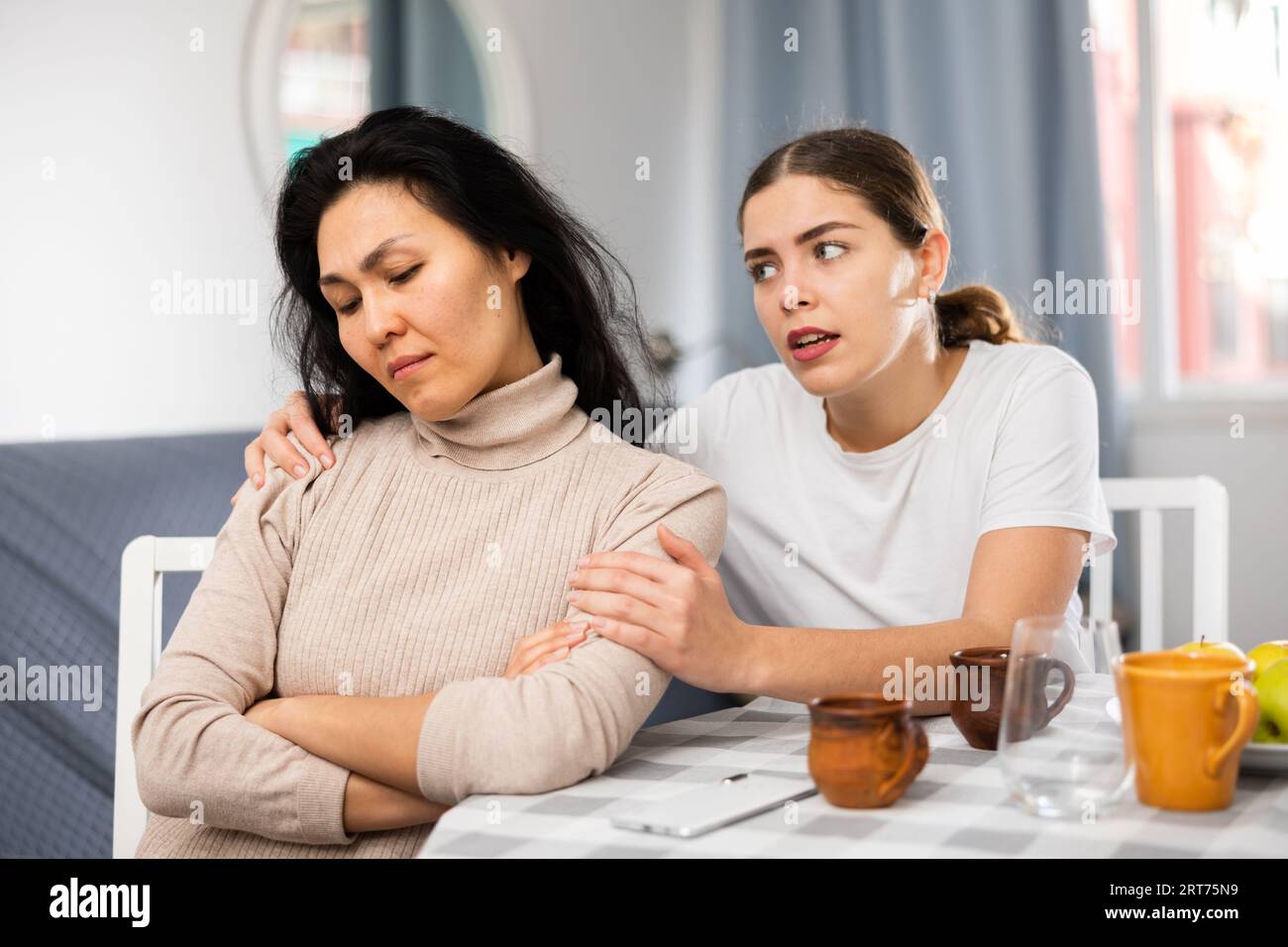 Young woman comforting her depressed female friend Stock Photo - Alamy