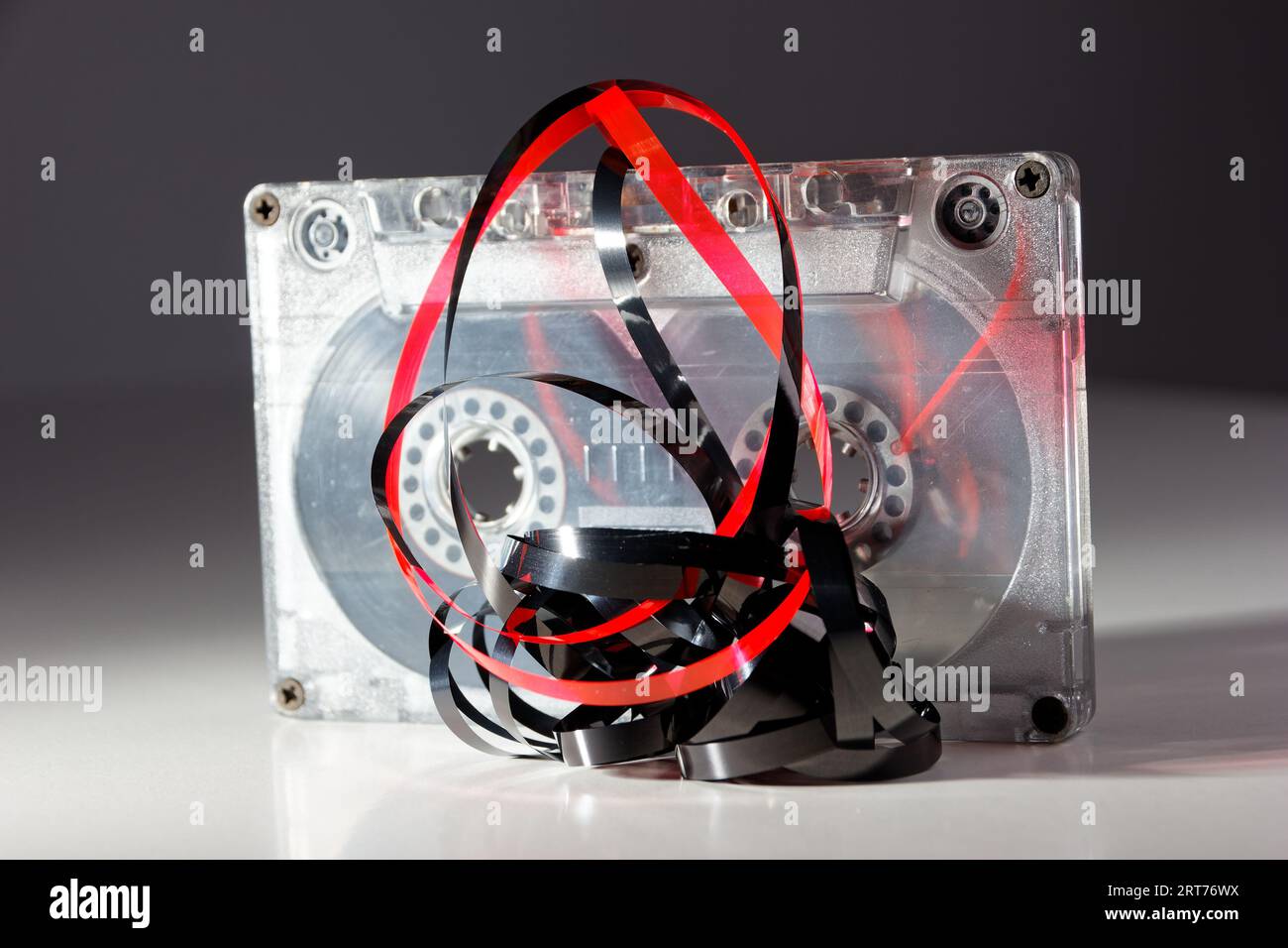 vintage analog audio cassette with transparent case and jammed tape ...