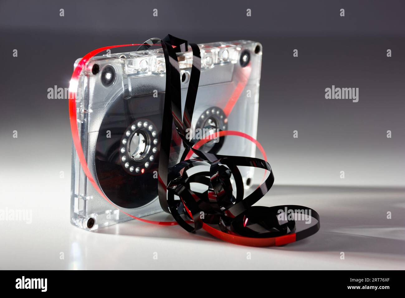 vintage analog audio cassette with transparent case and jammed tape ...