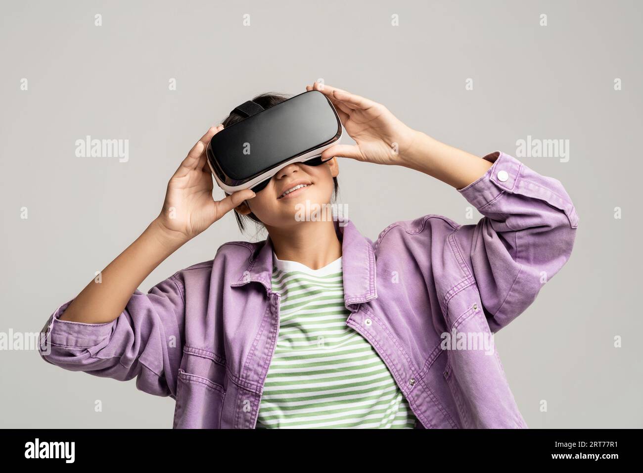 Teenager girl in virtual glasses goggles watching movie playing video ...