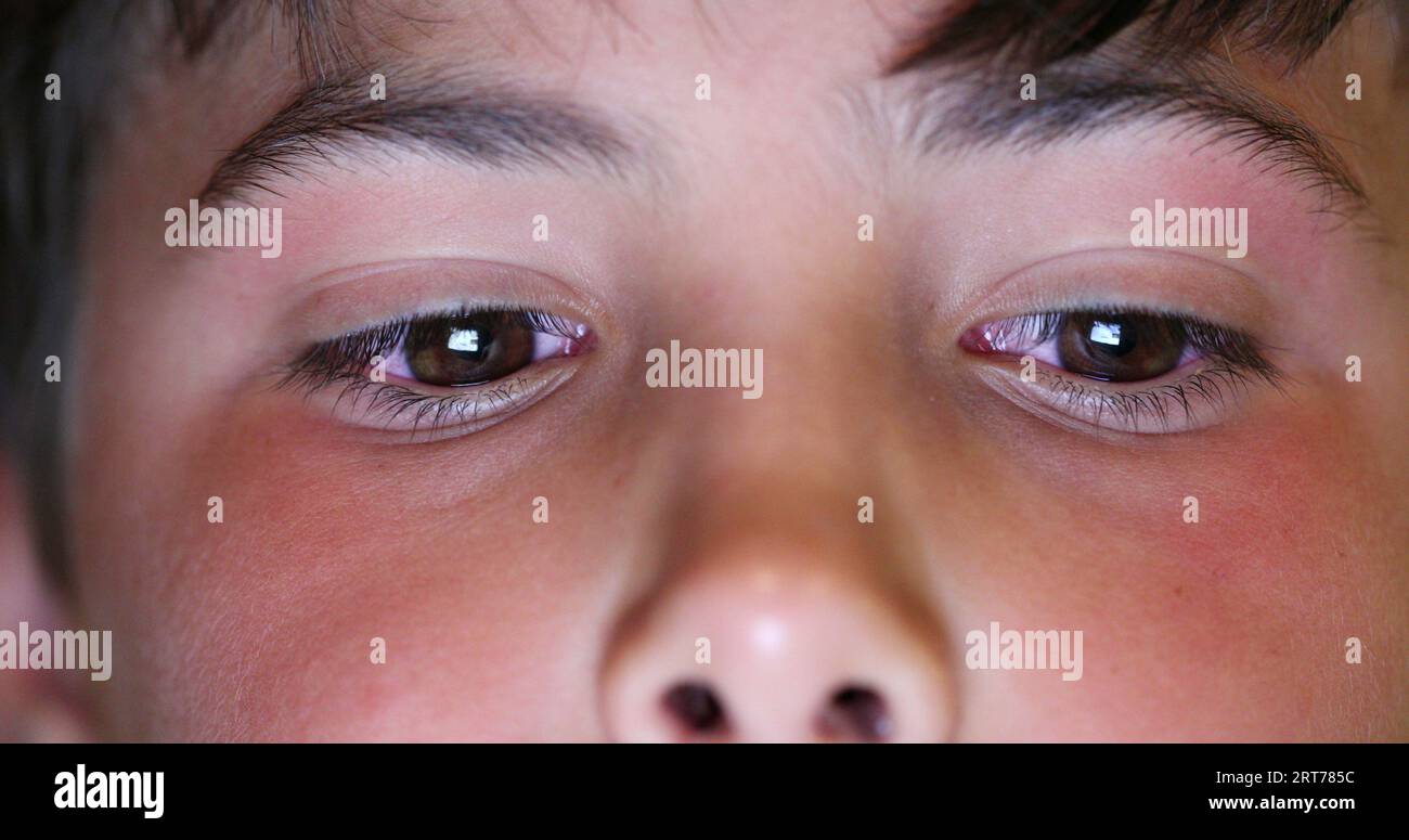 Boy eyes macro close-up watching content online. Child staring at blue ...