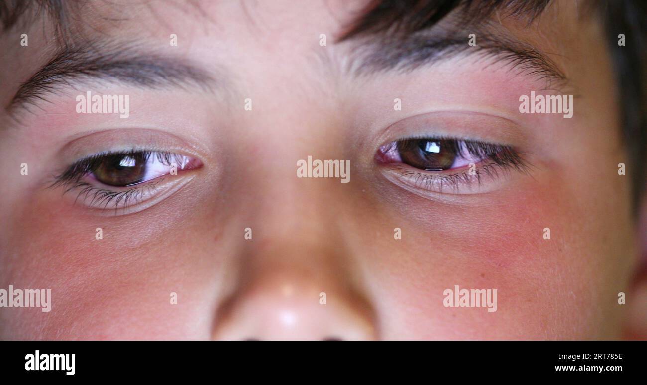 Boy eyes macro close-up watching content online. Child staring at blue ...