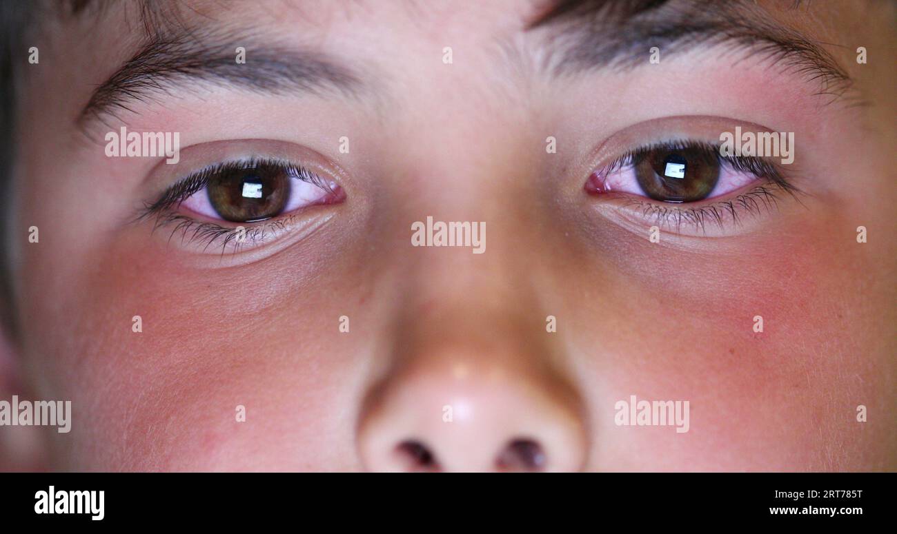 Boy eyes macro close-up watching content online. Child staring at blue ...