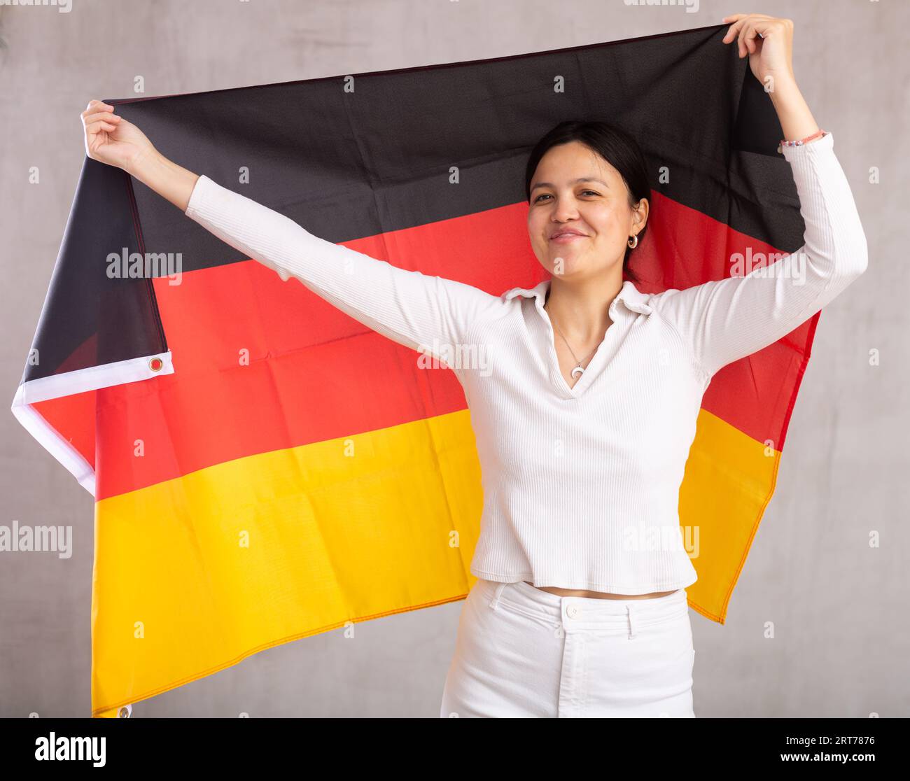 Young woman posing in studio with Germany flag Stock Photo - Alamy